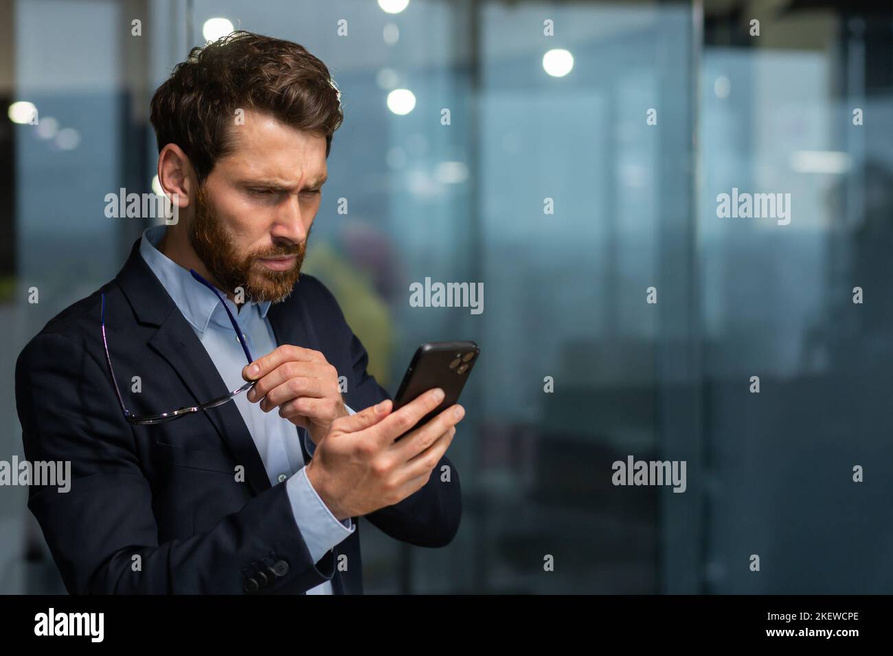 Mature businessman in office near window in evening upset reading ...