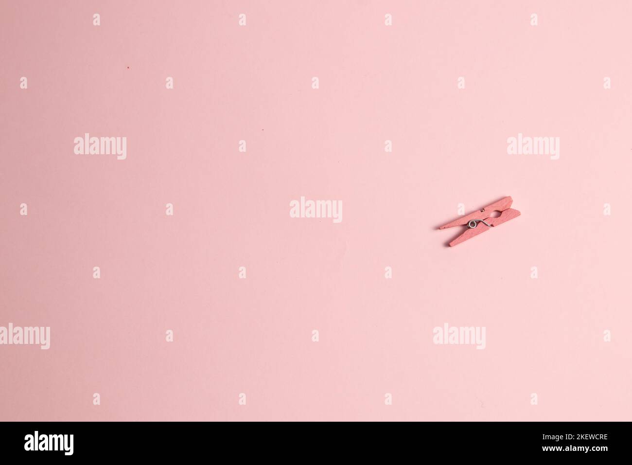 Pink clothespin on a pastel pink background Stock Photo - Alamy