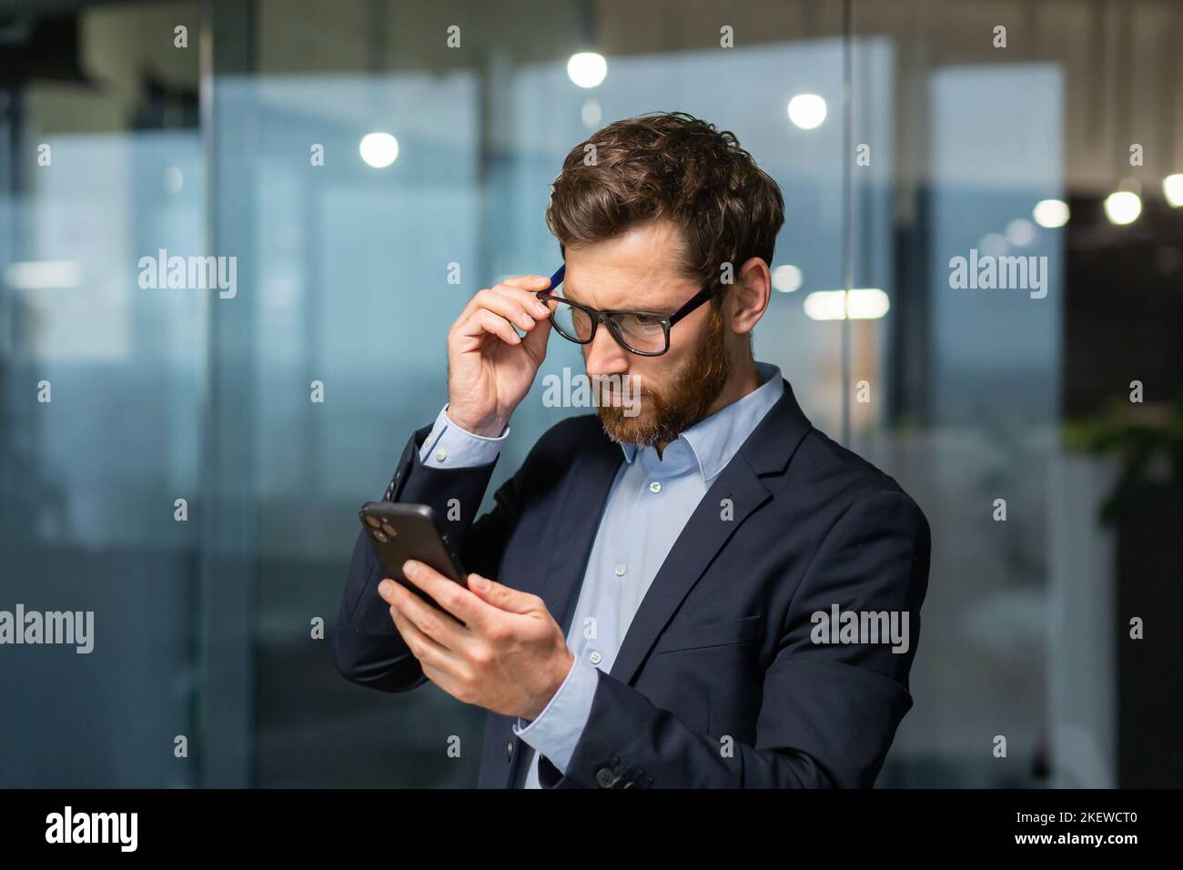 Mature businessman in office near window in evening upset reading ...