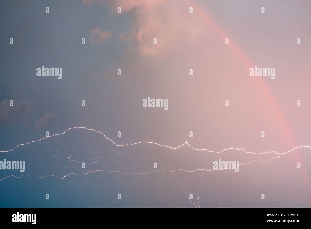 Electric lightning and rainbow in storm cloud. Alsace, France Stock ...