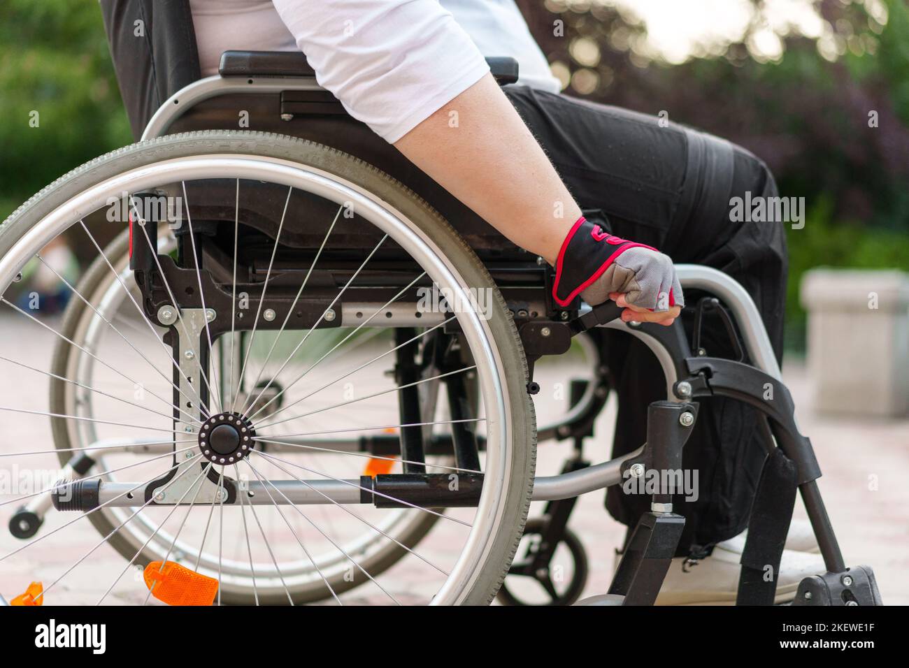 Unrecognizable woman with disability sitting in wheelchair in the ...