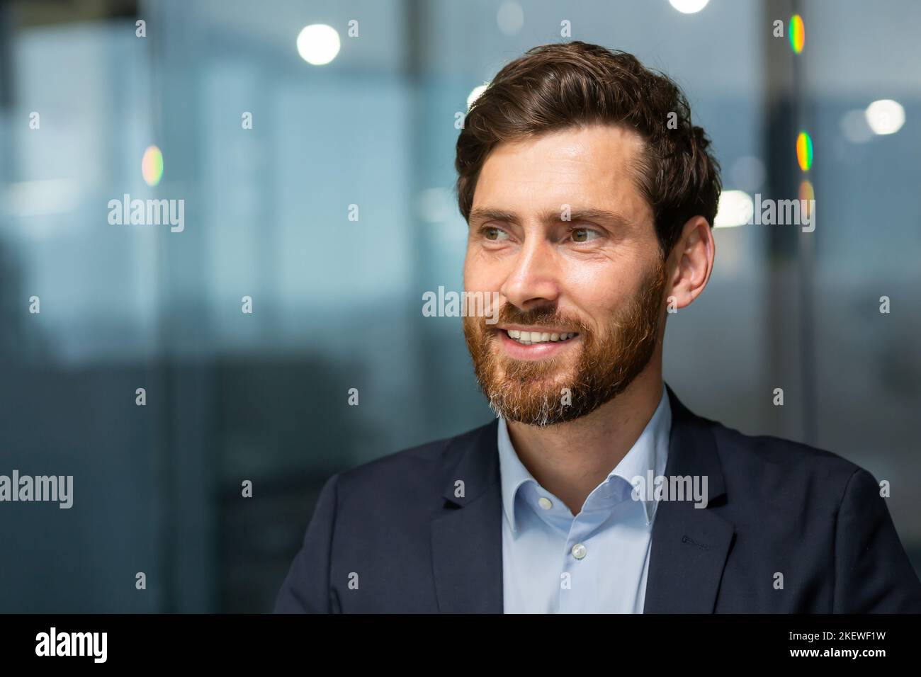 Close up photo of happy and smiling mature businessman inside modern ...