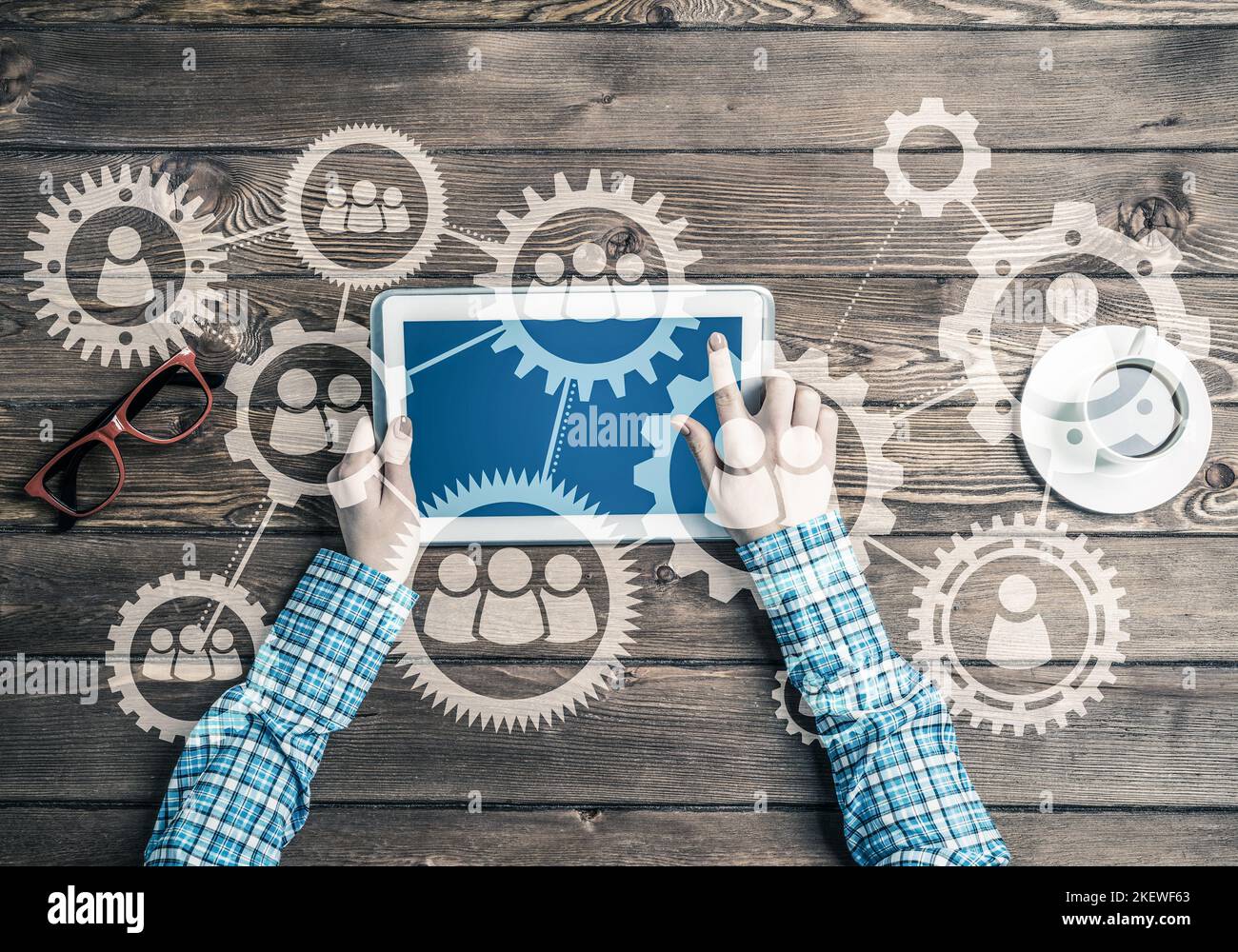 Concept of teamworking and connection with gears mechanism and tablet ...