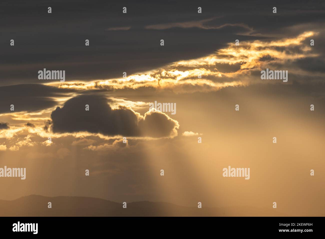 Beams of light of sun's rays through clouds in morning. Alsace, France ...