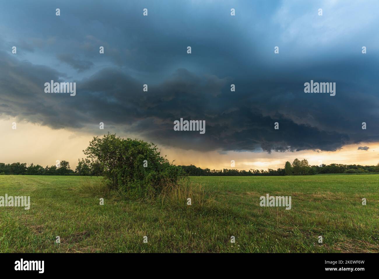 arge storm cell in a stormy sky over a meadow in summer. Alsace, France ...