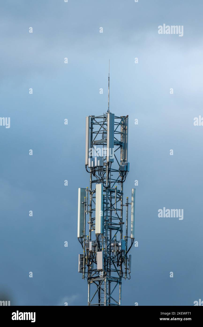 Telecommunication antenna in country village by cloudy weather. Alsace ...