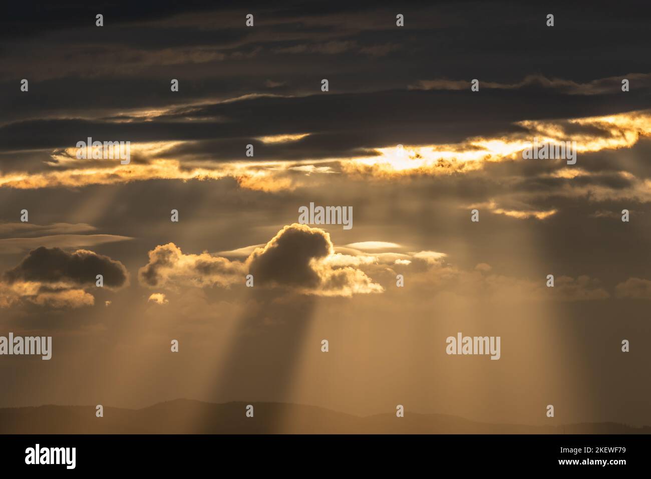 Beams of light of sun's rays through clouds in morning. Alsace, France ...