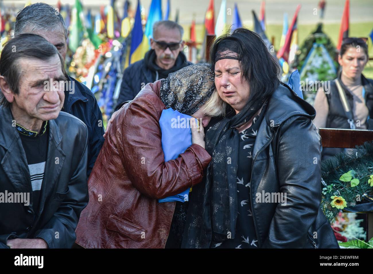 Lviv, Ukraine. 18th Oct, 2022. Relatives mourn during the funeral ...