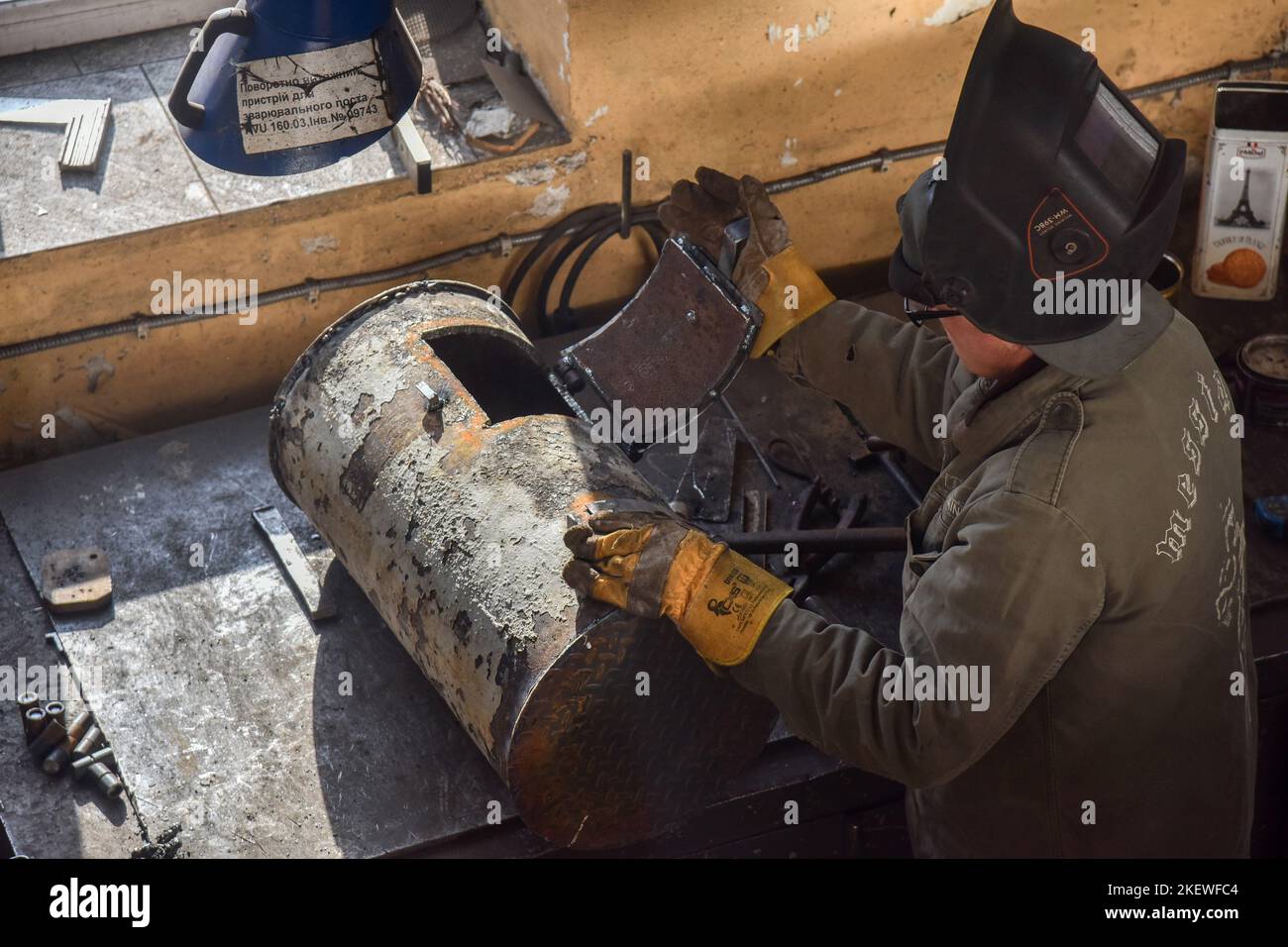 A worker of one of the Lviv utility companies makes a special metal ...