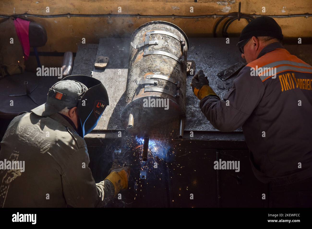 Workers of one of the Lviv utility companies make a special metal stove ...