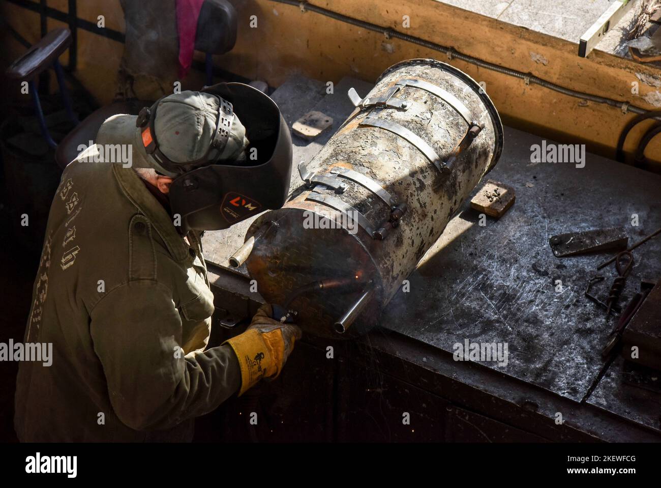 A worker of one of the Lviv utility companies makes a special metal ...