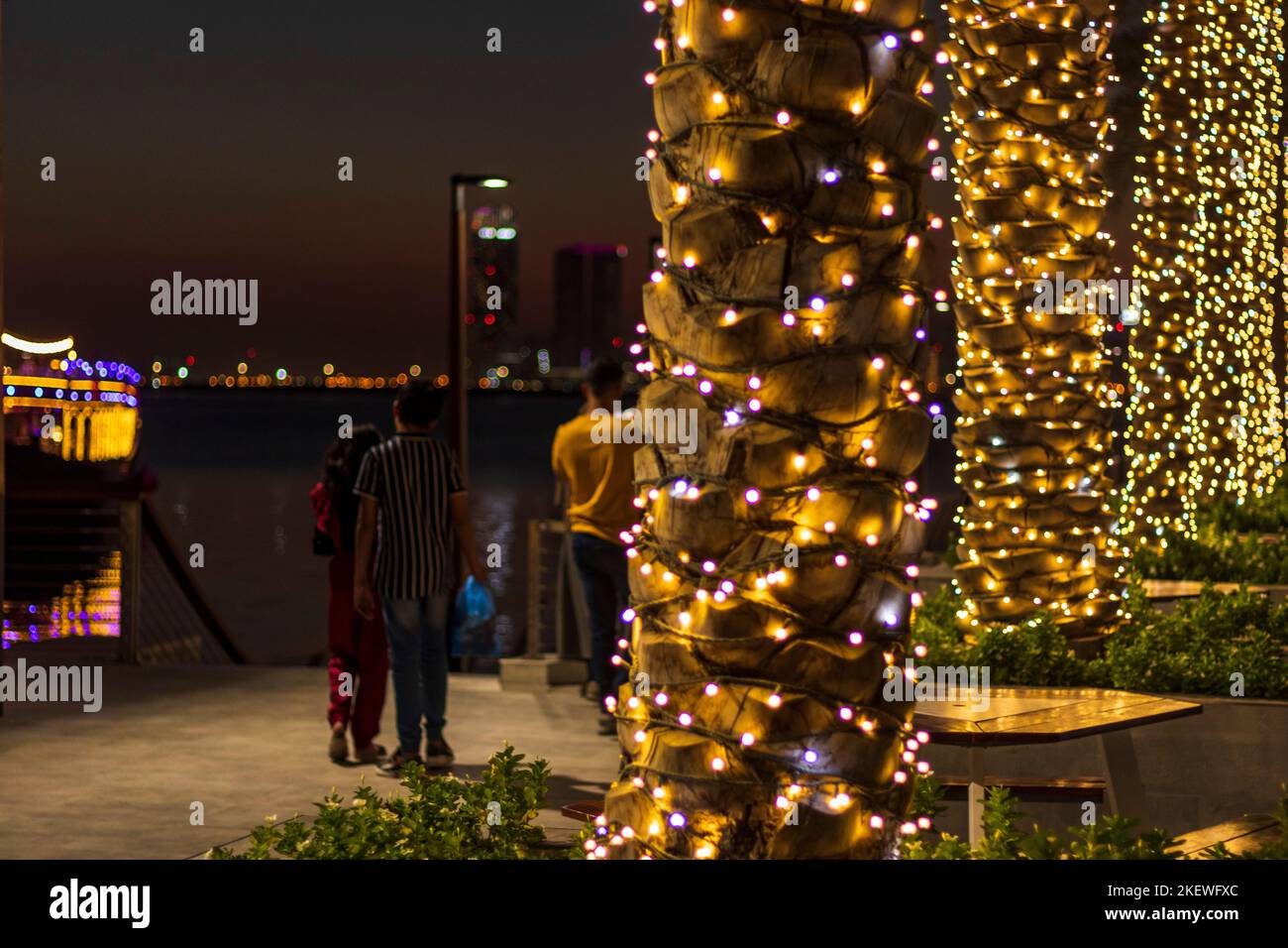 People walking at the waterfront in the night Stock Photo - Alamy
