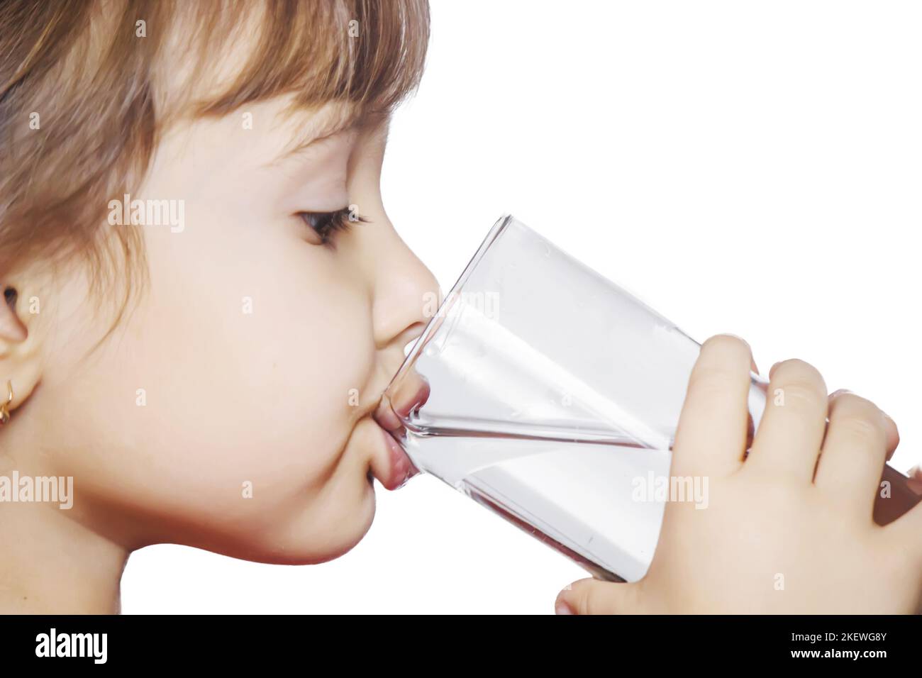 The child drinks water from a glass of isolate. Selective focus. Kid Stock Photo - Alamy
