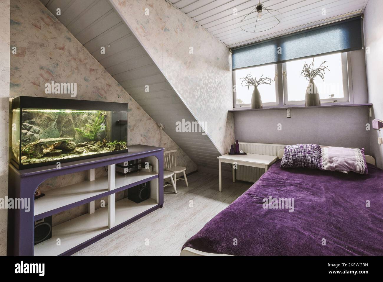 Home interior design of bedroom with bed and wooden wardrobe placed in ...