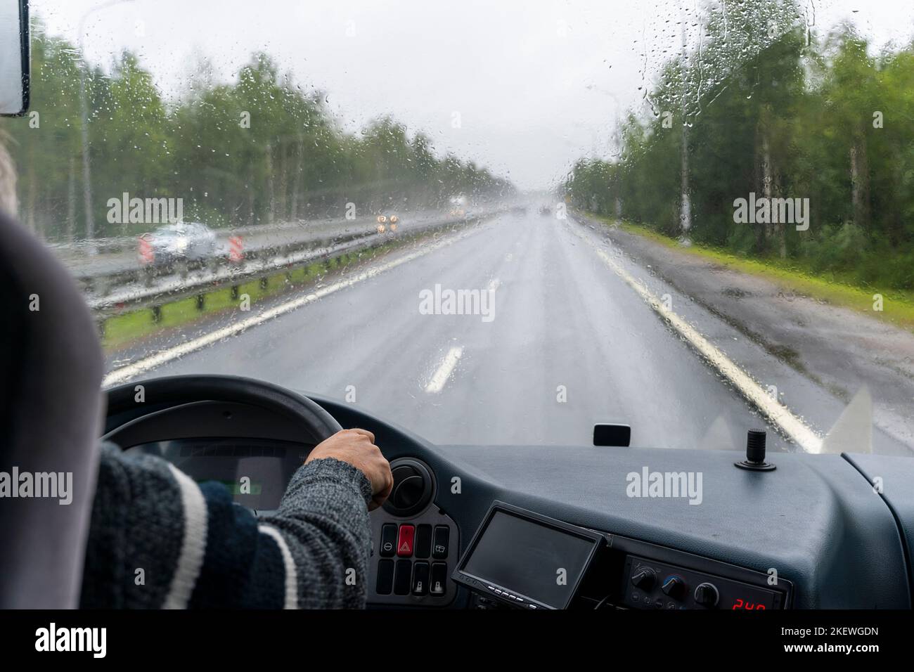 view through the windshield of a tourist bus moving along the highway ...