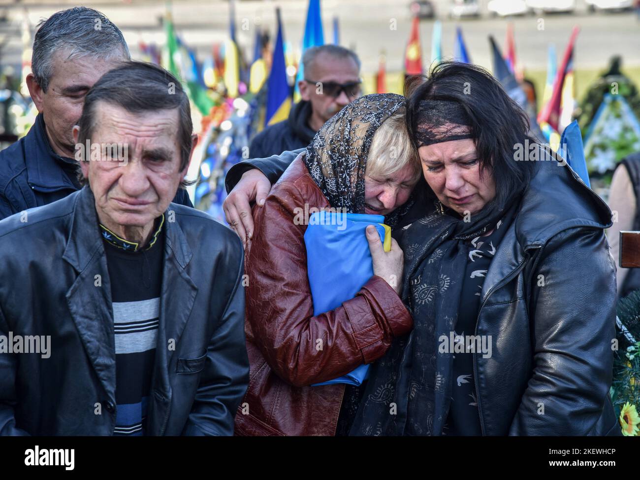 Lviv, Ukraine. 18th Oct, 2022. Relatives mourn during the funeral ...