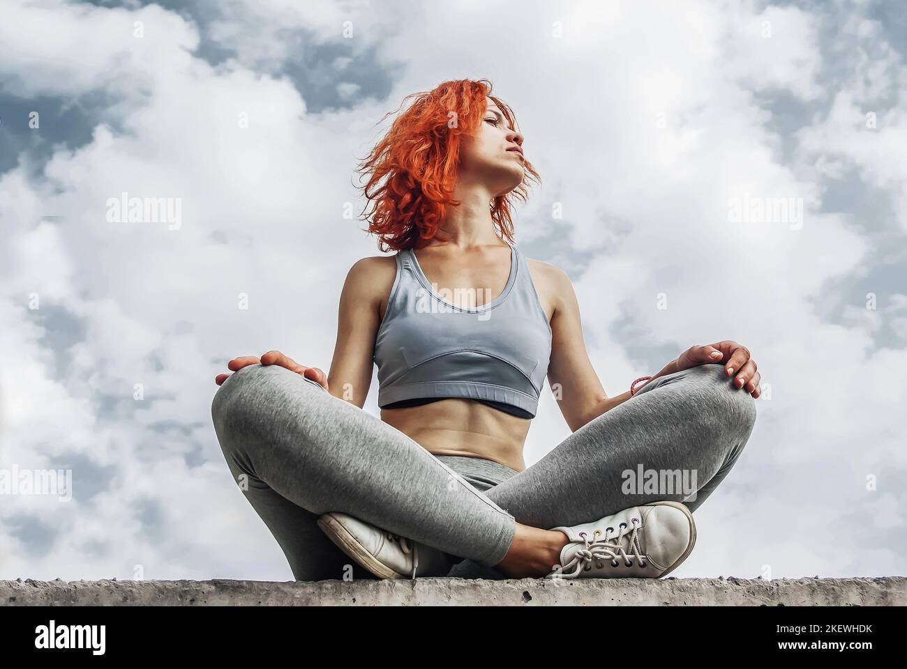 Female racer seated on a panel pointing Stock Photo - Alamy
