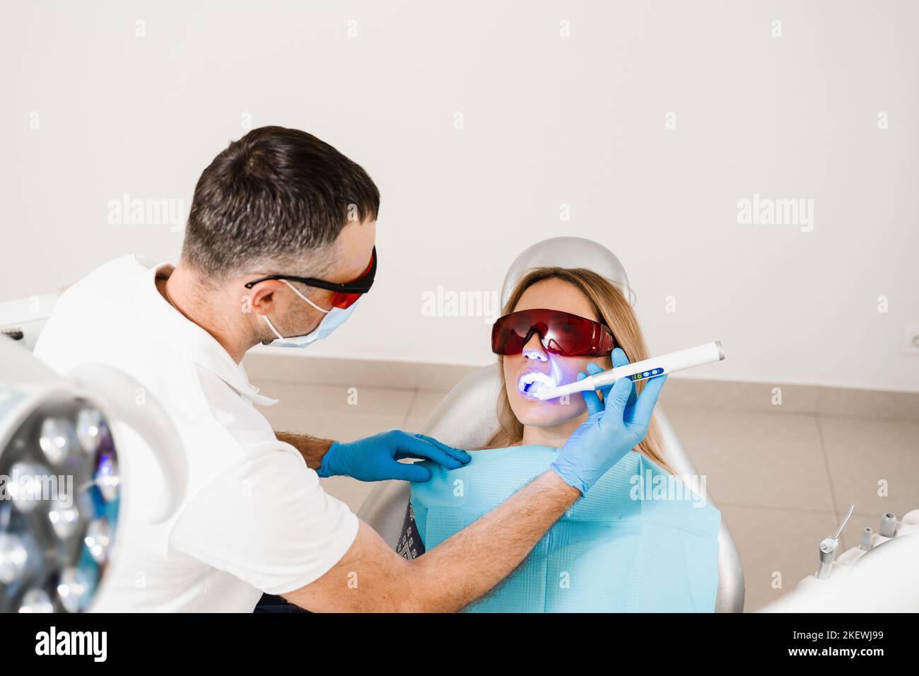 Uv illumination of photopolymer tooth filling for woman in dentistry ...