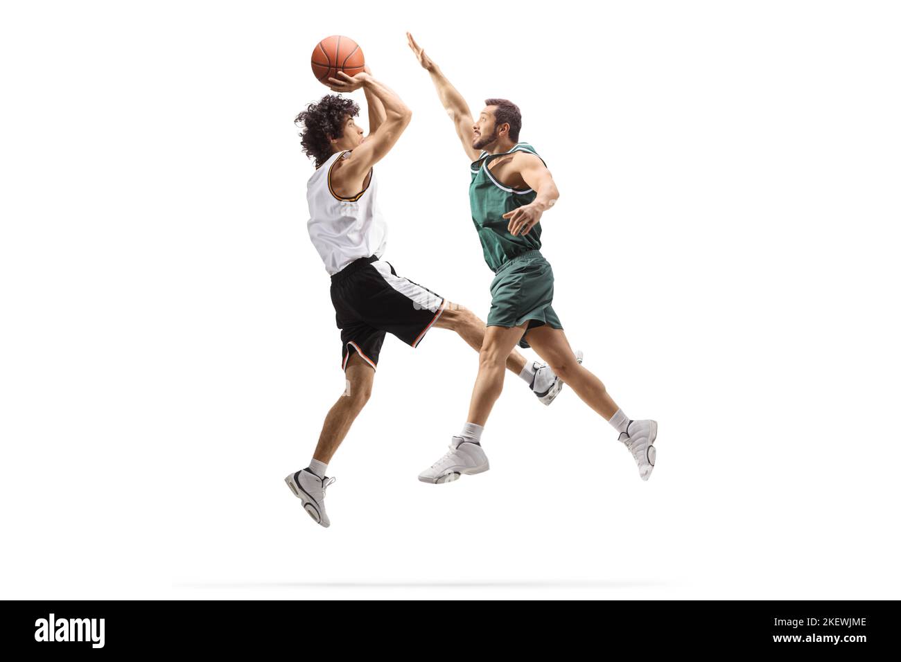 Basketball player jumping and performing blocking to another player ...