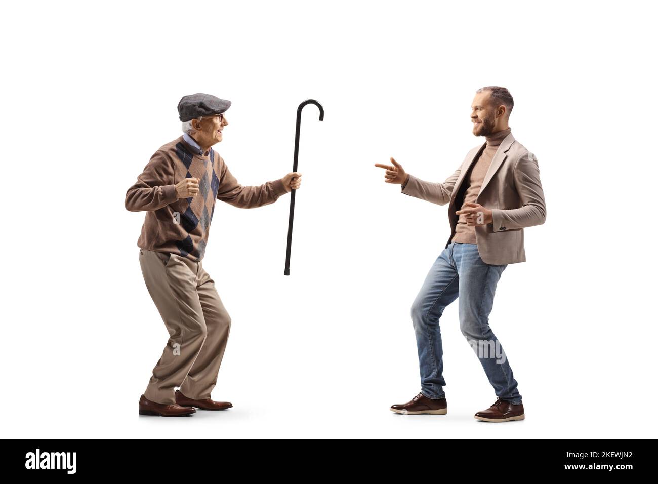 Full length profile shot of an elderly and younger man dancing isolated ...