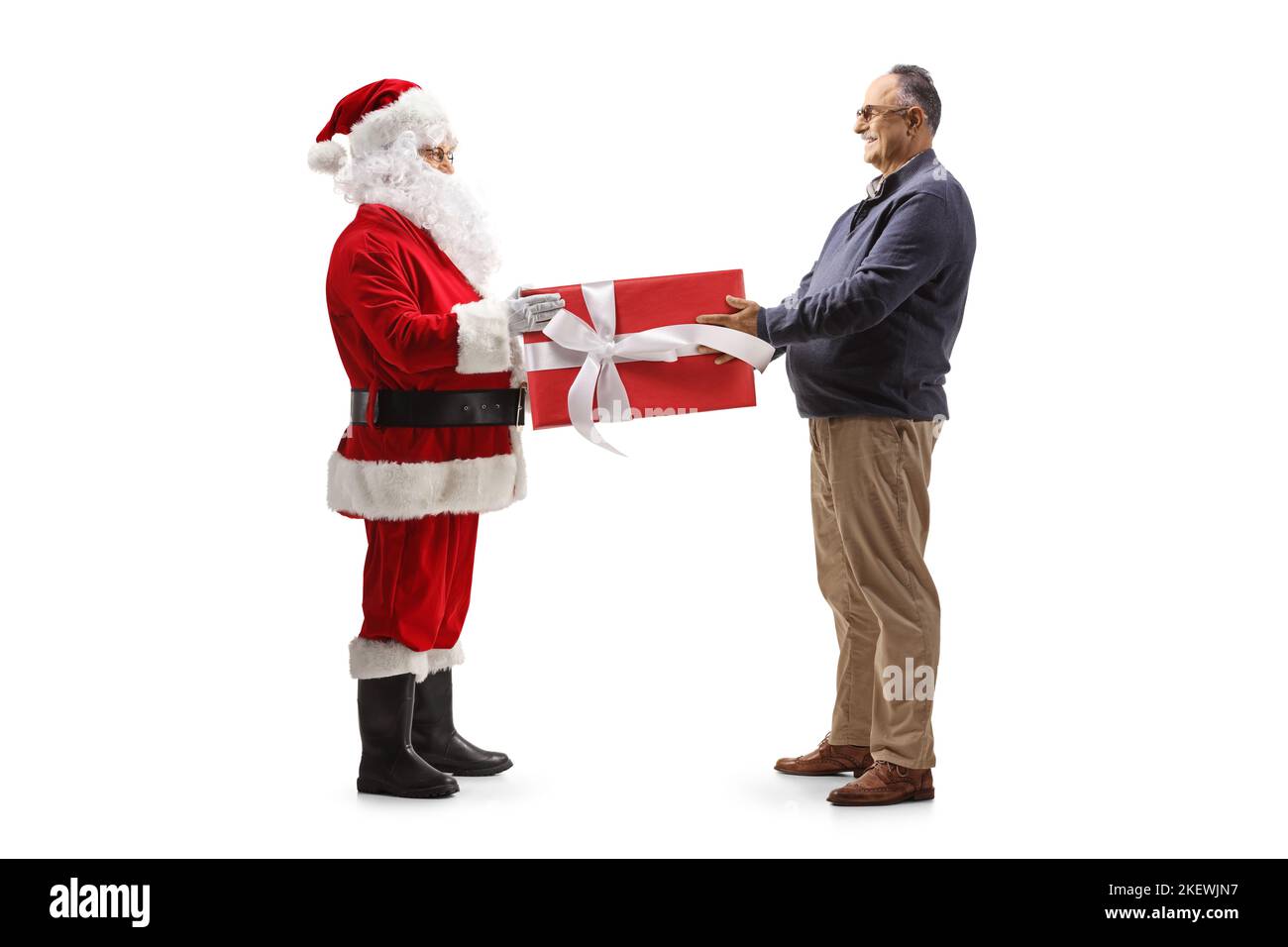 Full length profile shot of santa claus handing a present box to a ...