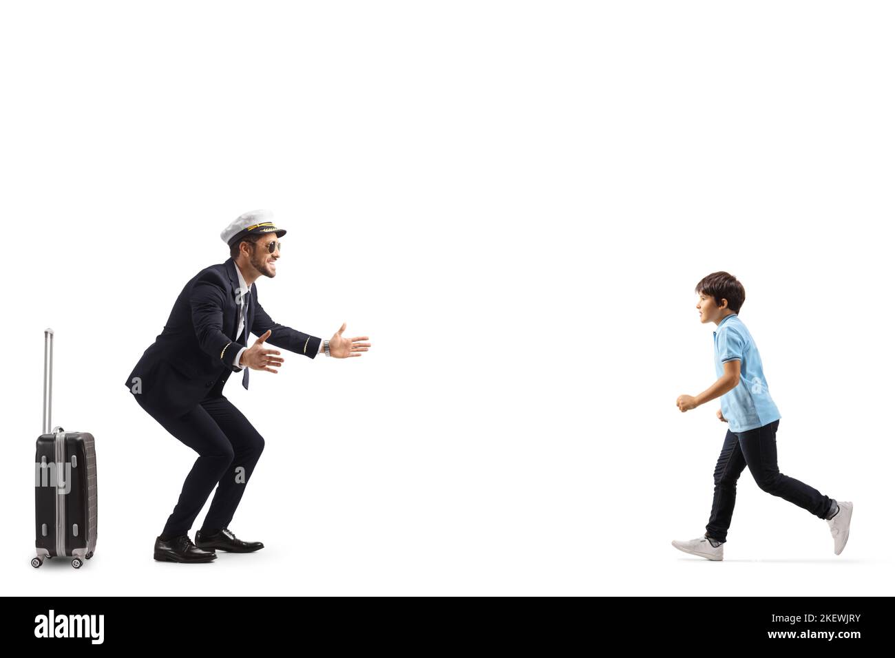 Full length profile shot of a little boy running to hug a pilot ...