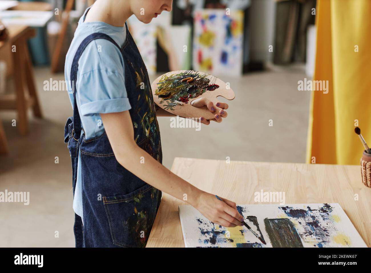 Cropped shot of young craftswoman with color palette working over ...