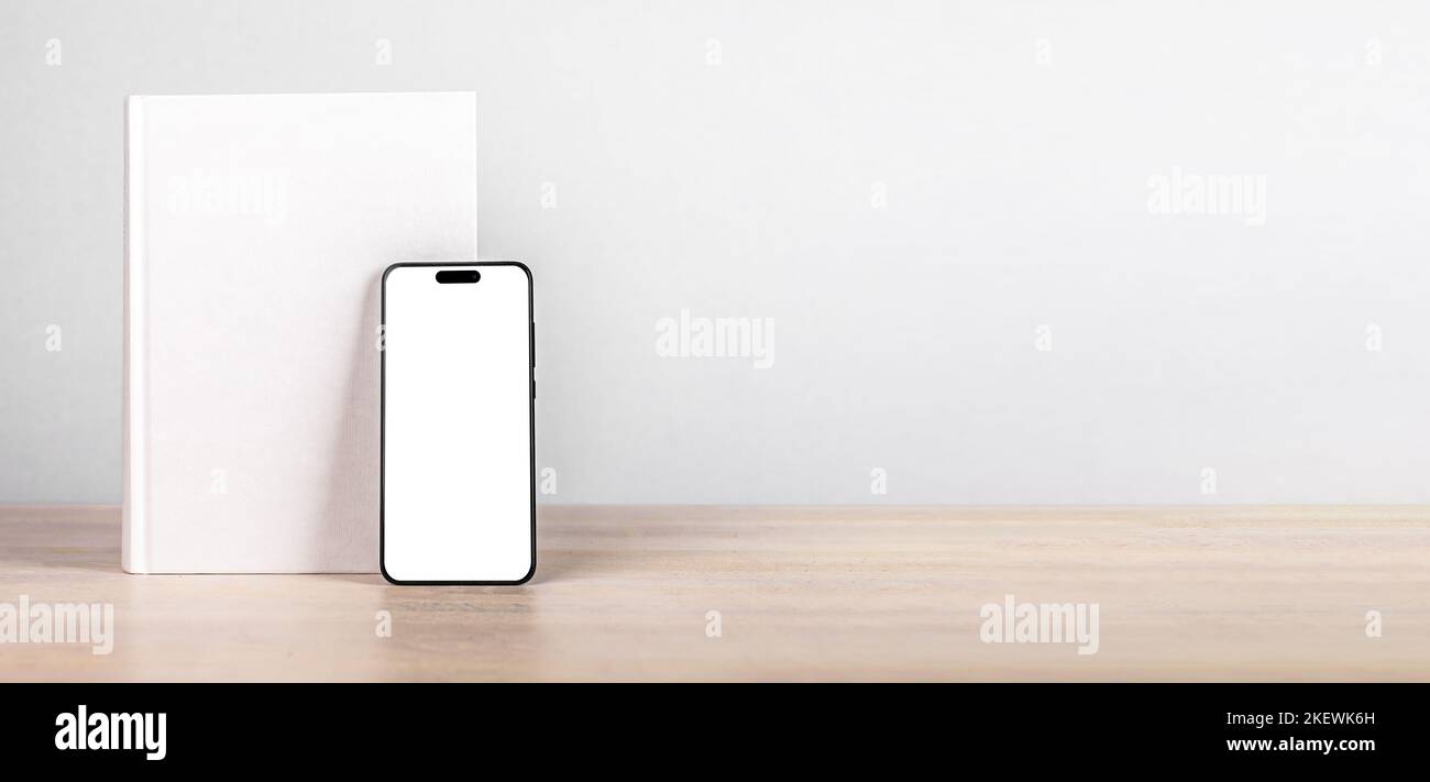 MINSK, BELARUS - NOVEMBER 14 2022 Book hard cover mock up and iphone 14 ...