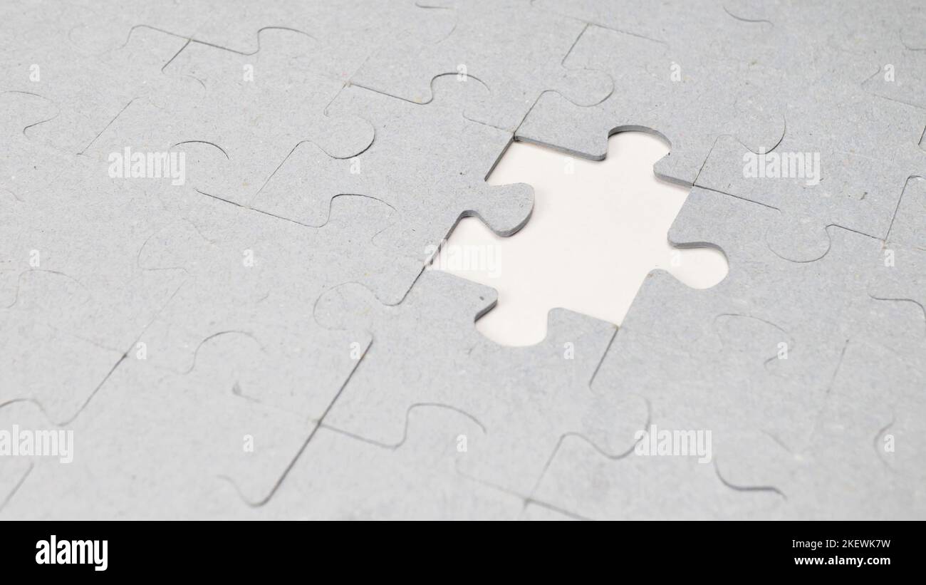 White jigsaw puzzle pattern background. placing last piece of jigsaw ...