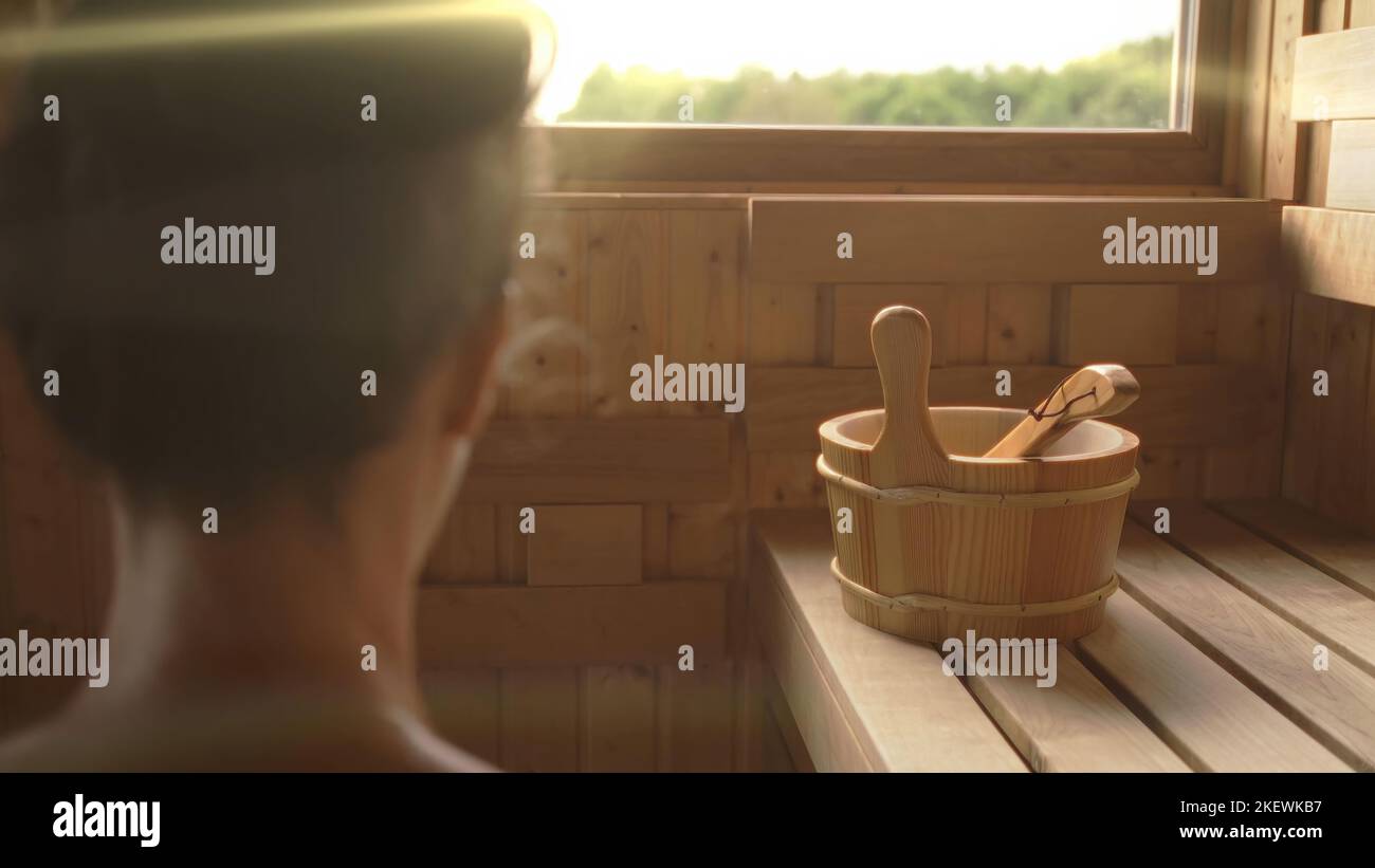 Woman relaxing and sweating in hot sauna. Real, authentic sauna moment ...