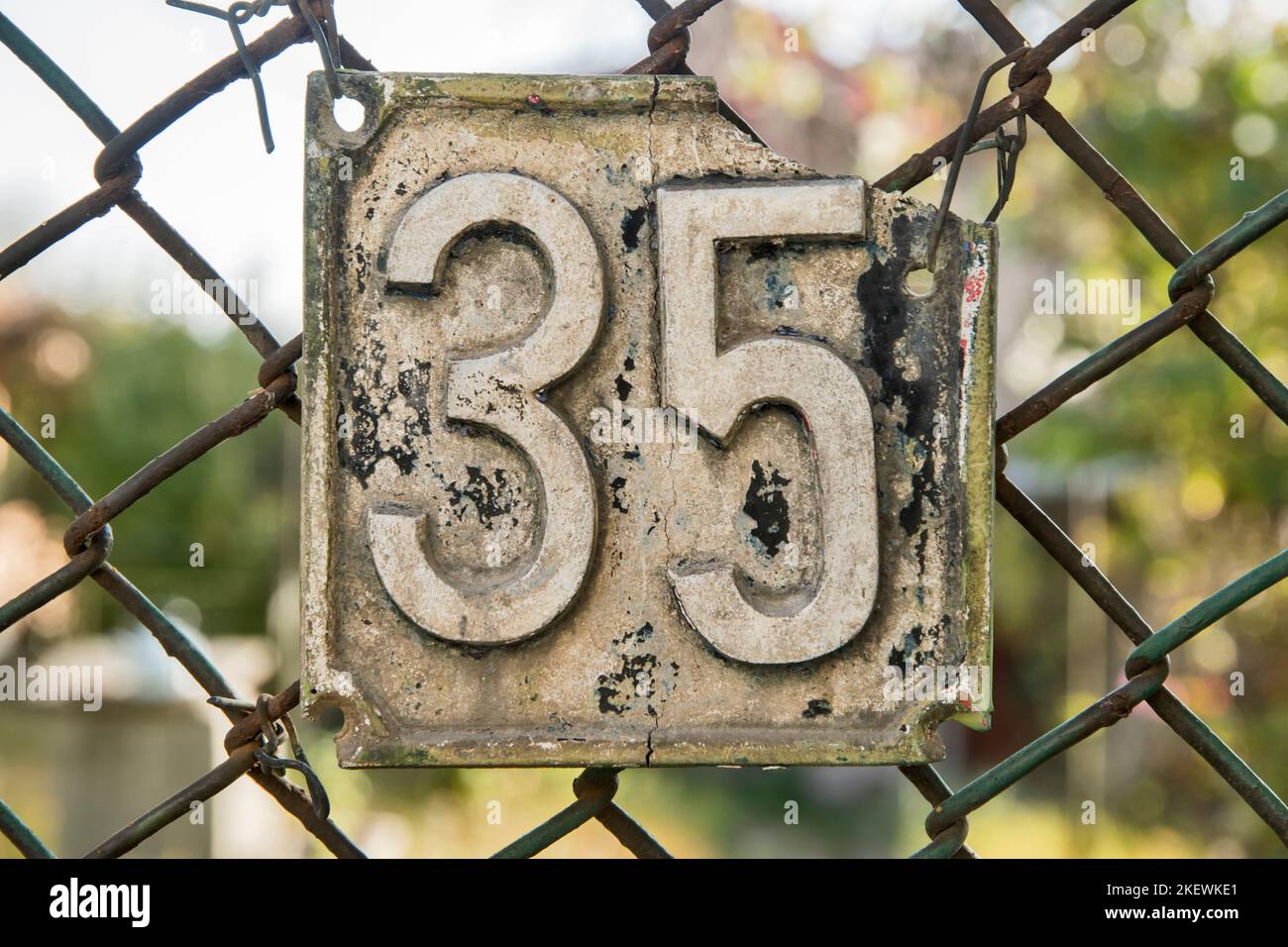 Old retro weathered cast iron plate number 35 closeup Stock Photo - Alamy