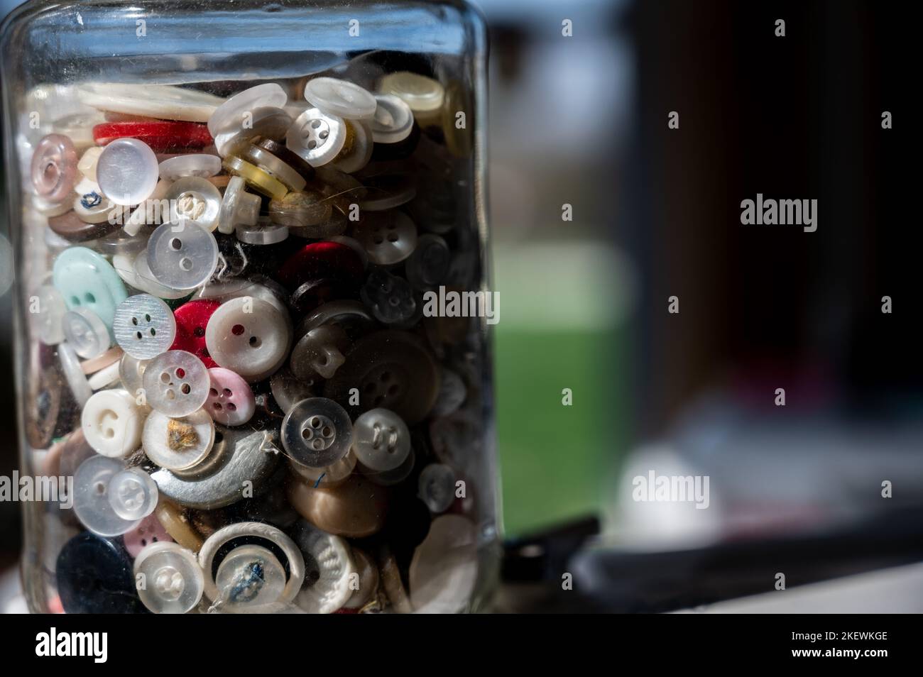 Old buttons in glass jar hi-res stock photography and images - Alamy