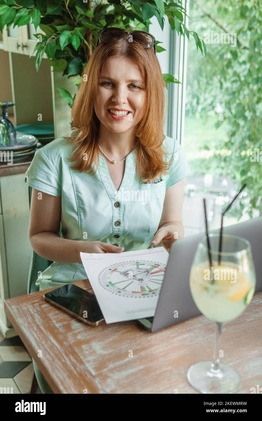 A woman with a laptop is studying human design. The concept of studying ...