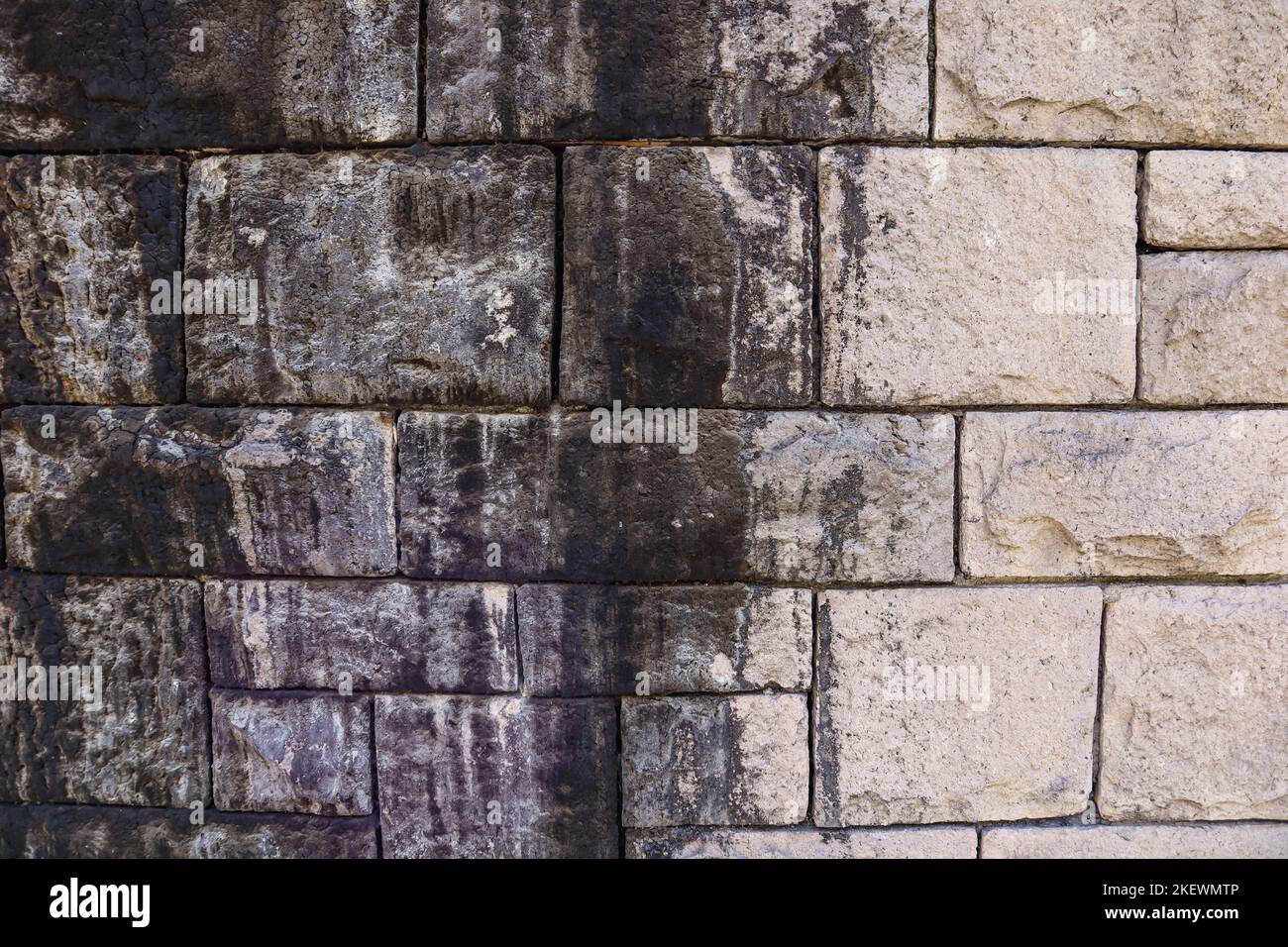 Brick wall split in two dark side and bright side aged Stock Photo - Alamy