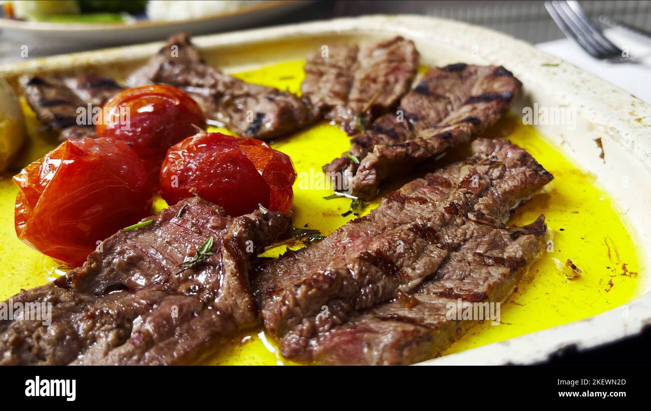 Medium Cooked Cow Meat Tomato and Olive Oil in a Plate Photo Stock ...