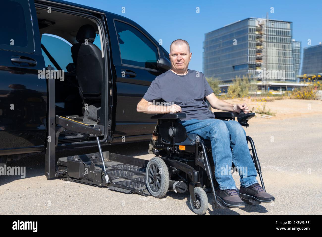 Disabled man in a wheelchair standing on the car lift Stock Photo - Alamy
