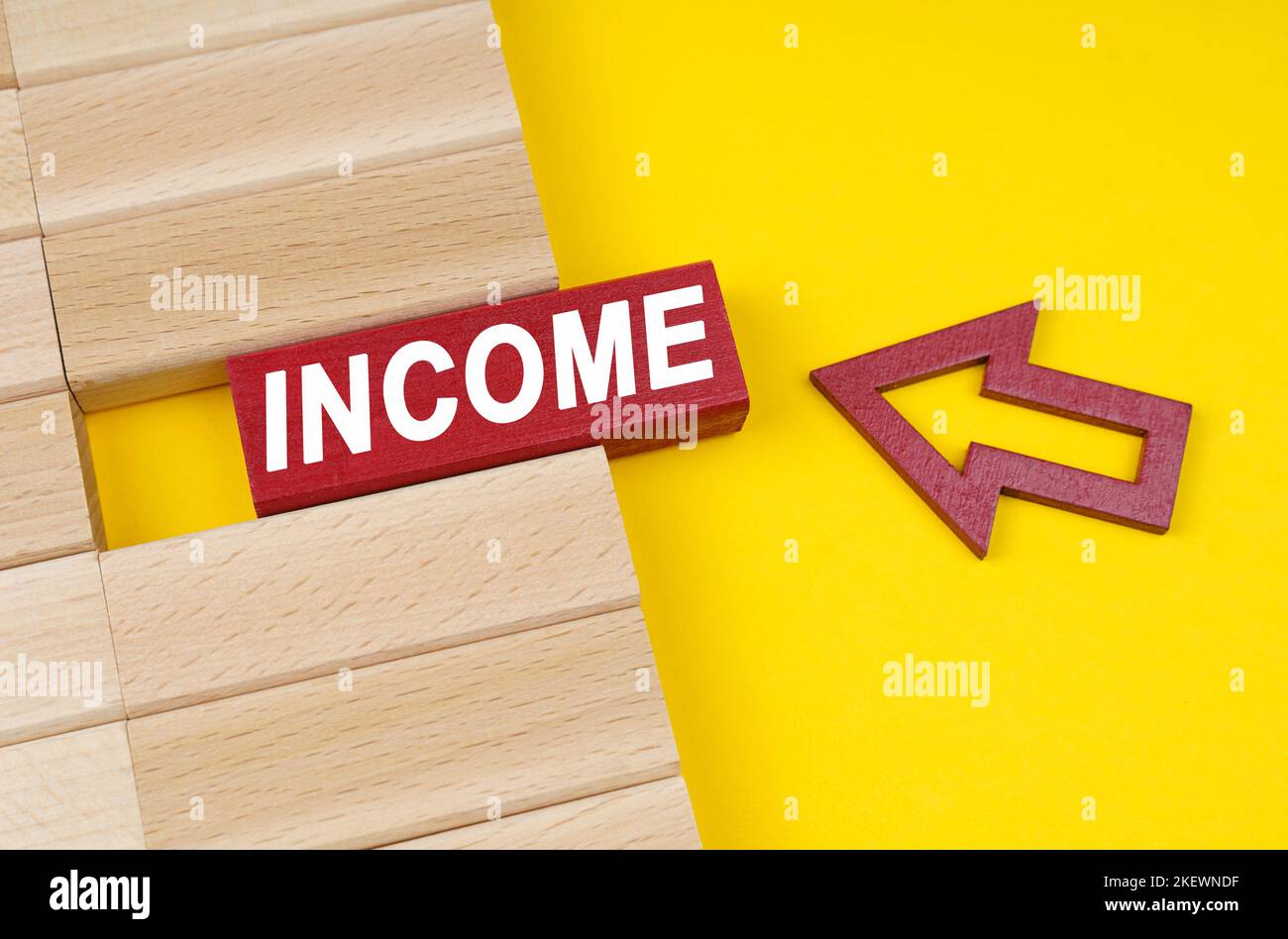 Business concept. On a yellow surface are wooden blocks and an arrow ...