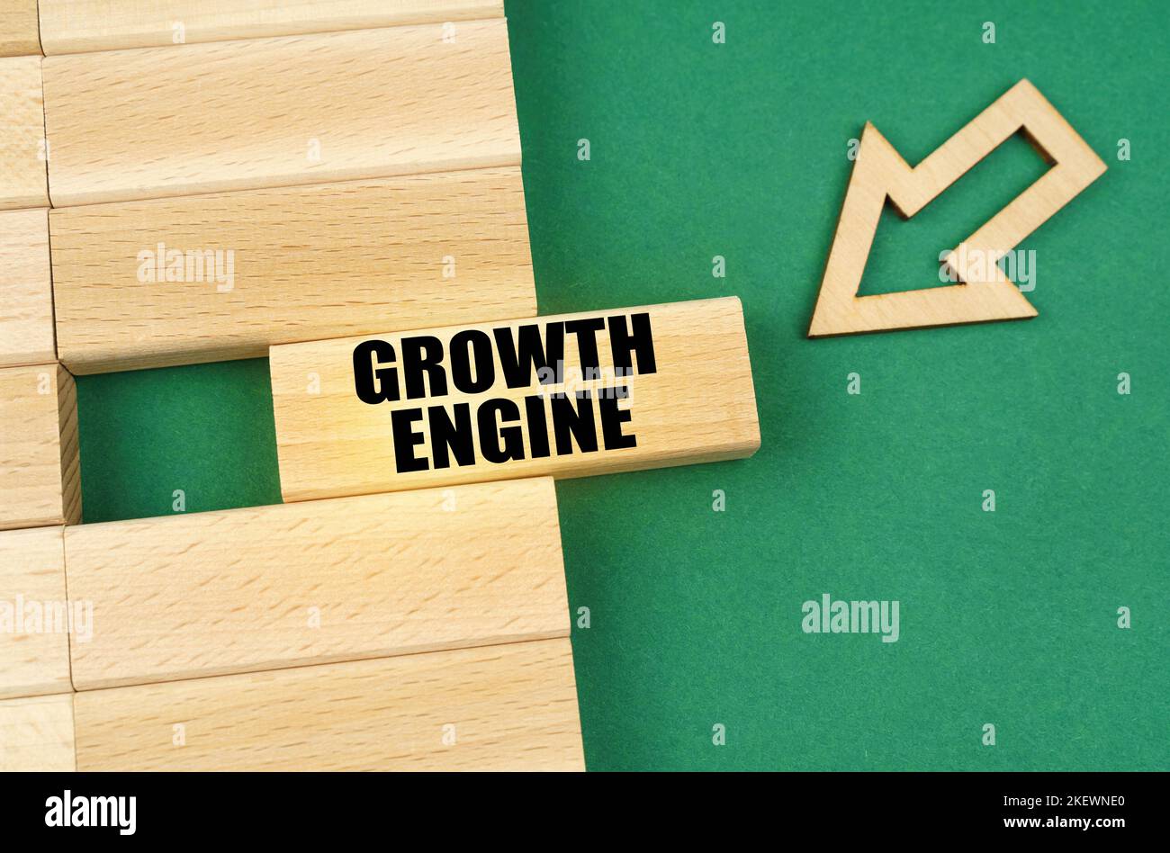 Business concept. On the green surface are wooden plates and an arrow ...