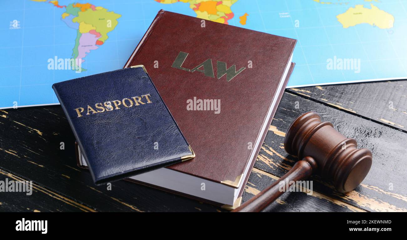 Judge's gavel, book, world map and passport on table. Immigration law ...