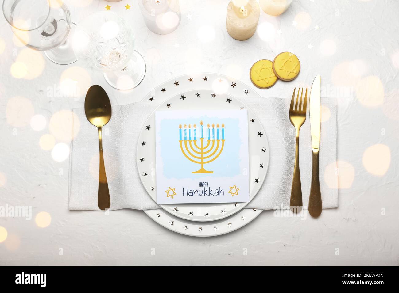 Table setting for Hanukkah celebration on white background, top view ...