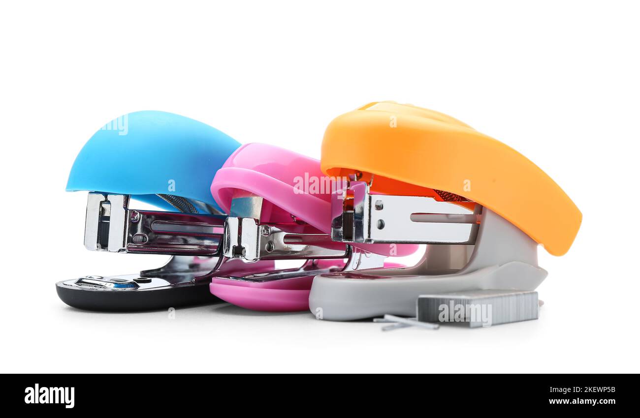 Colorful office staplers on white background Stock Photo - Alamy