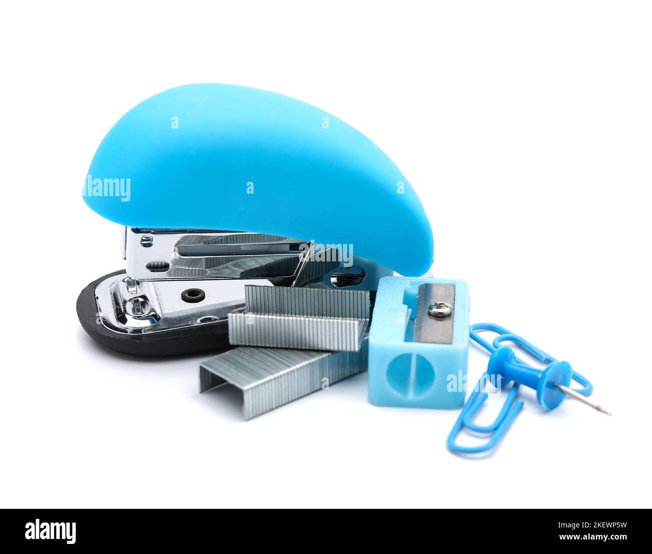 Office stapler, sharpener, paper clips and staples on white background ...