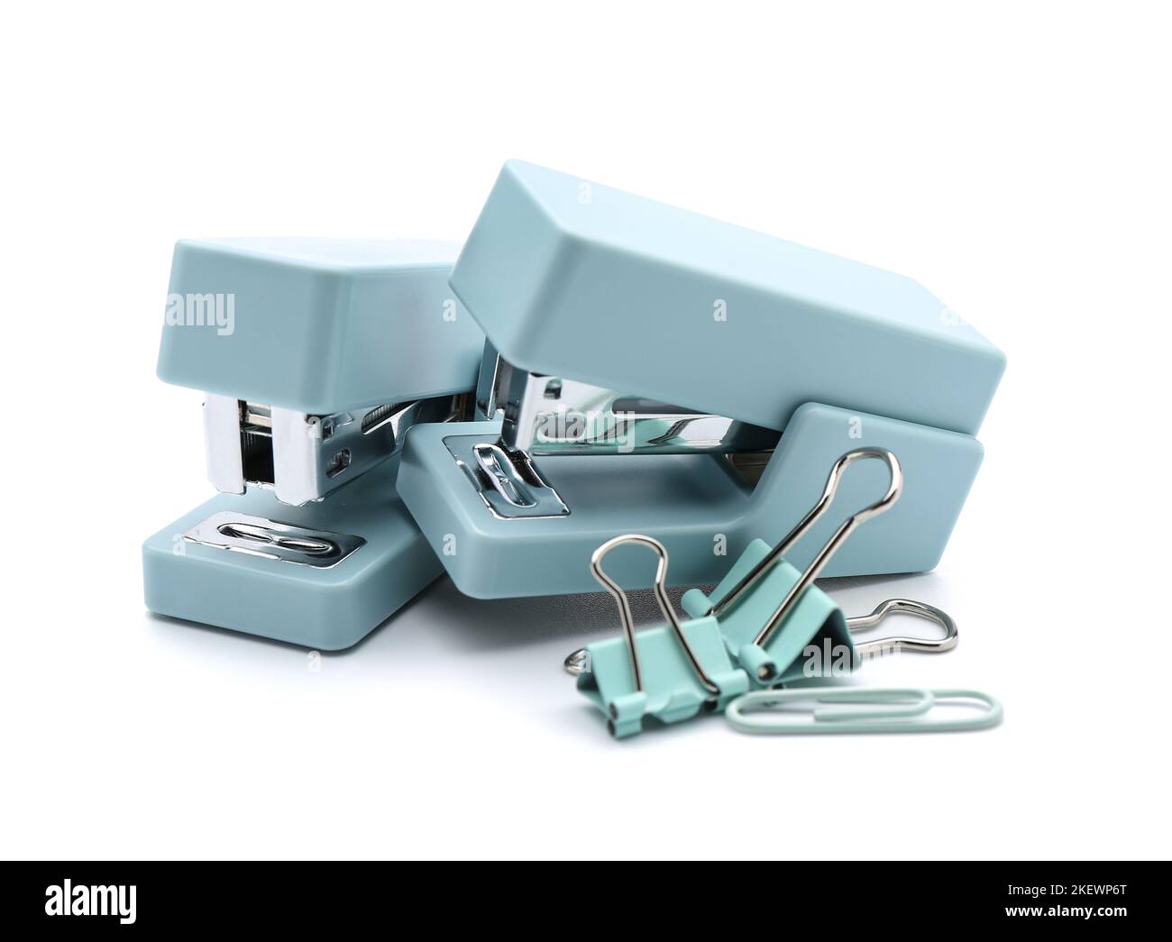 Office staplers and paper clips on white background Stock Photo - Alamy