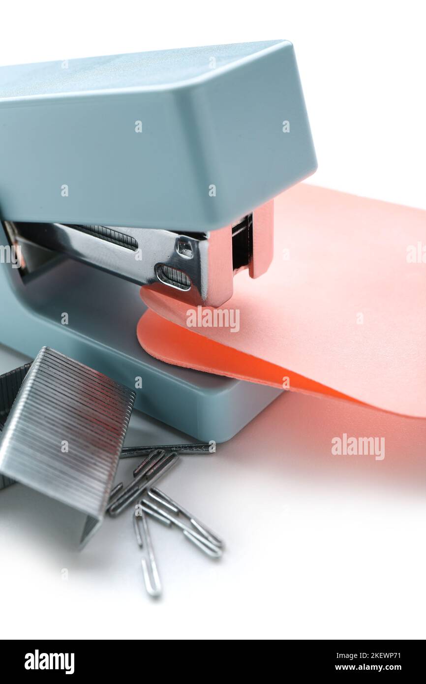 Stapler with sticky notes and staples on white background, closeup ...