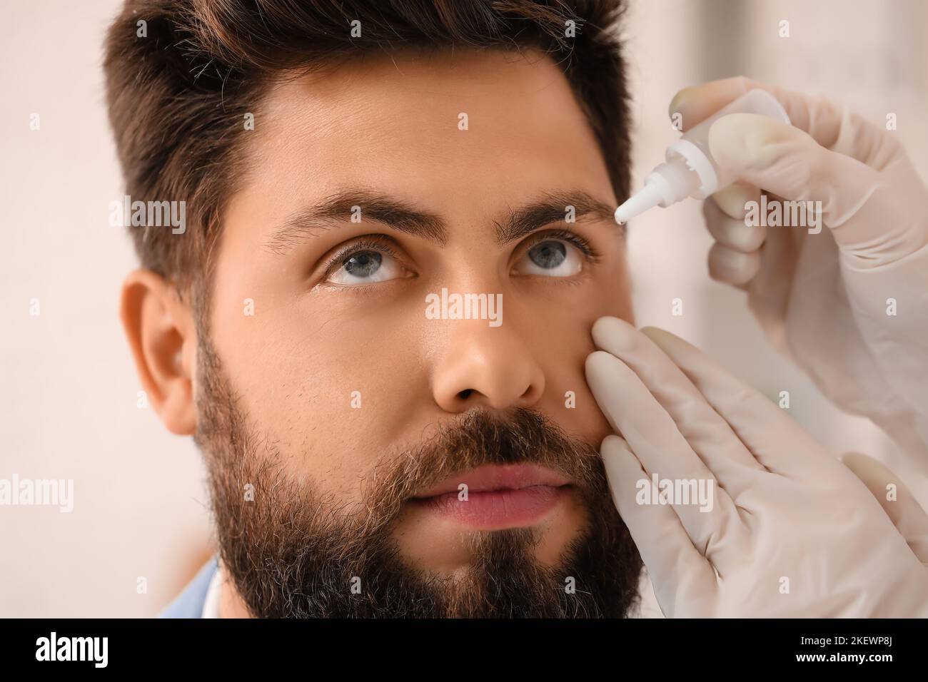 Man putting eye drops in his eyes hi-res stock photography and images ...