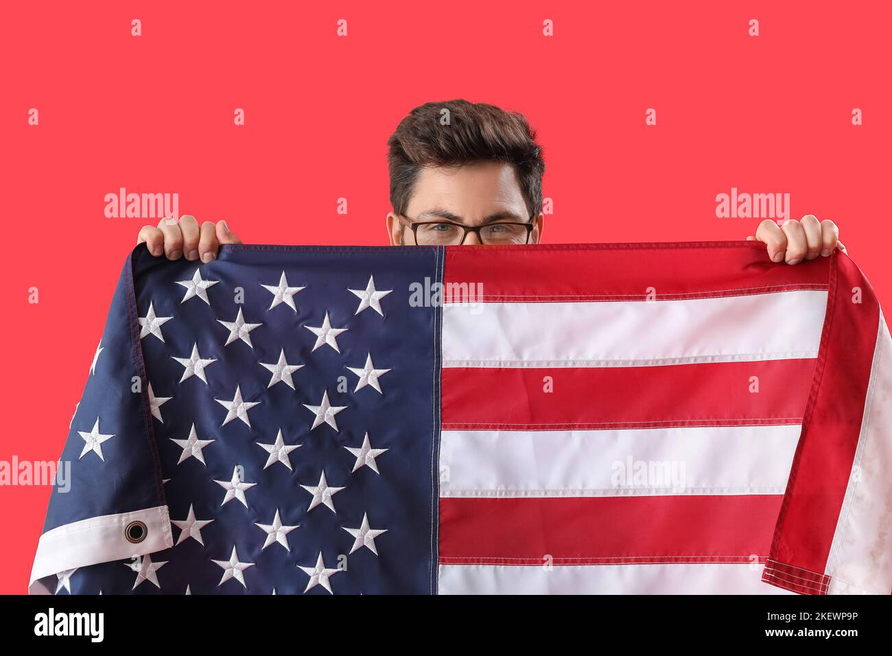 Handsome man with USA flag on red background Stock Photo - Alamy