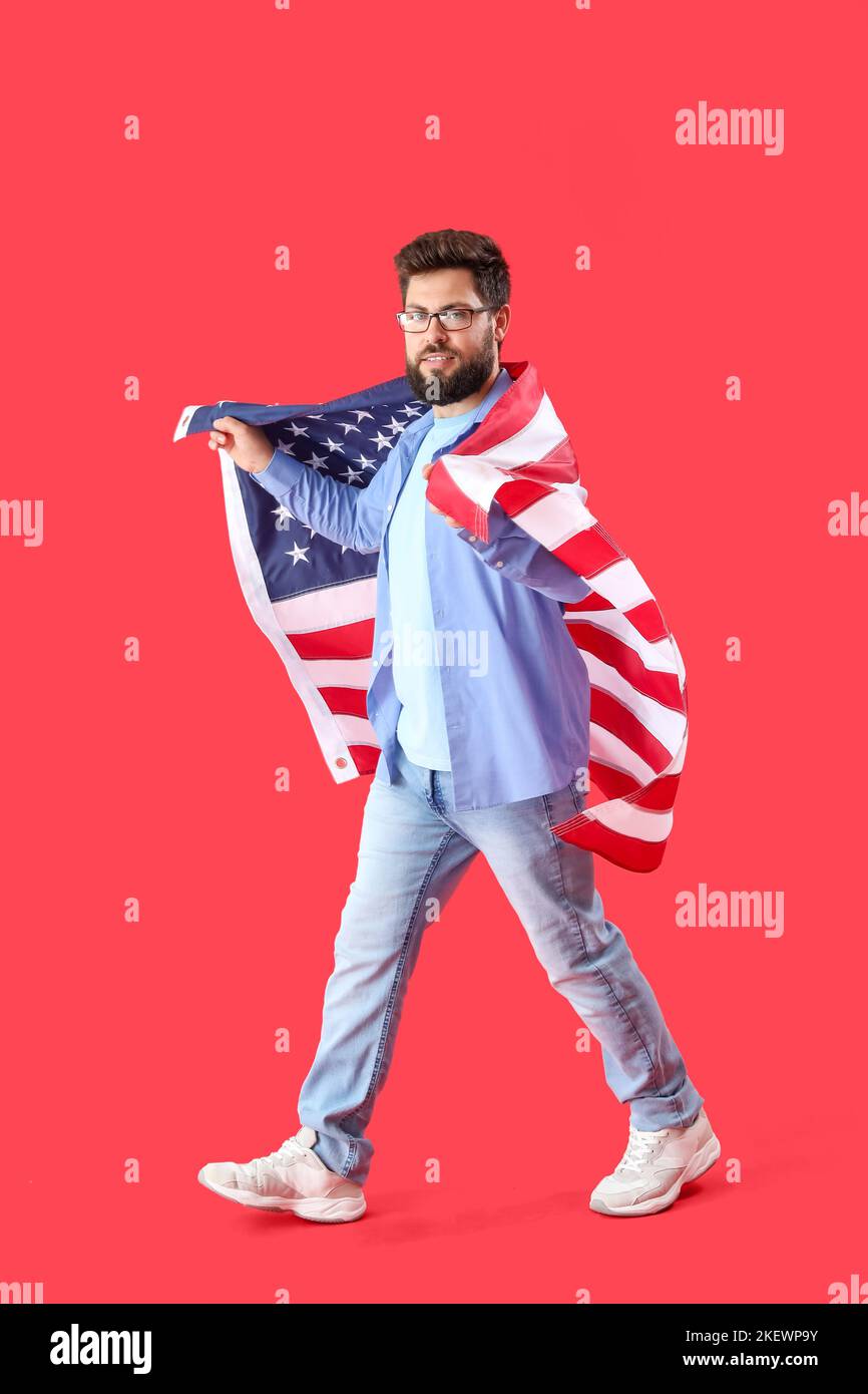 Handsome bearded man with USA flag on red background Stock Photo - Alamy