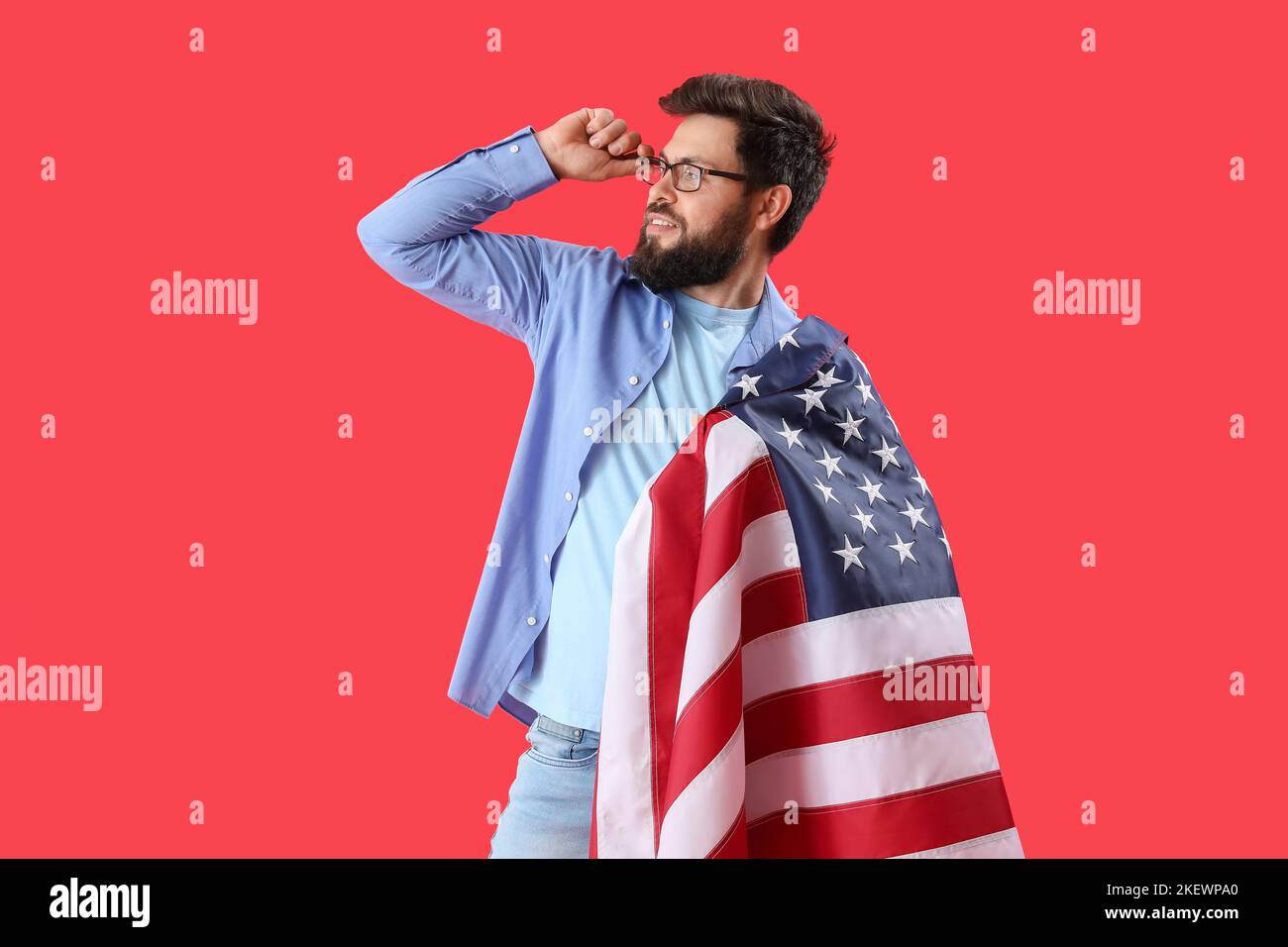 Handsome bearded man with USA flag on red background Stock Photo - Alamy