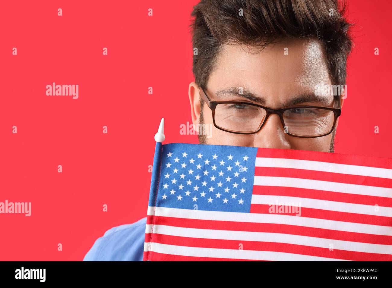 Handsome man with USA flag on red background, closeup Stock Photo - Alamy