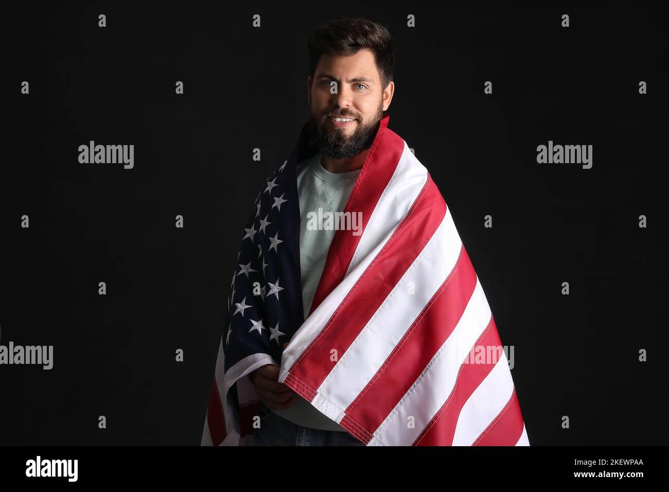 Handsome bearded man with USA flag on black background Stock Photo - Alamy